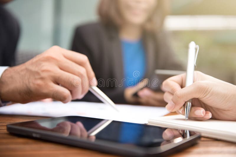 Business People Writing and Discussing Documents Stock Photo - Image of ...