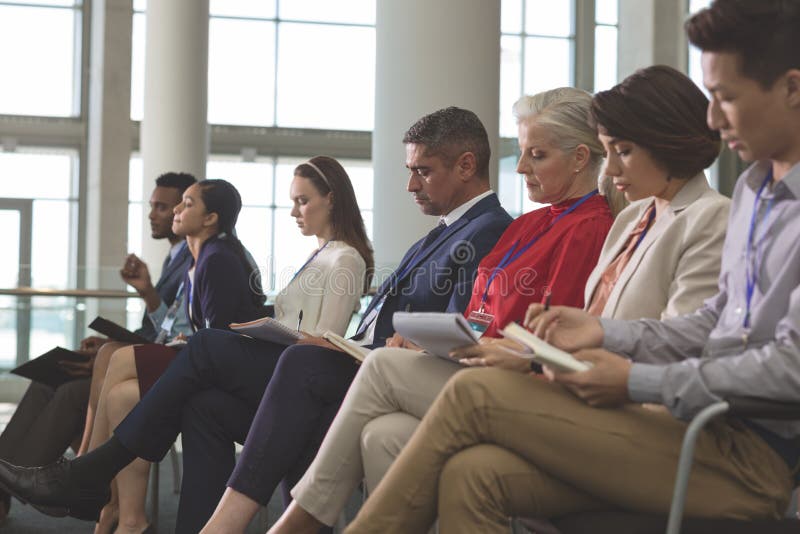 Business People Writing on Notepad in a Business Seminar Stock Image ...
