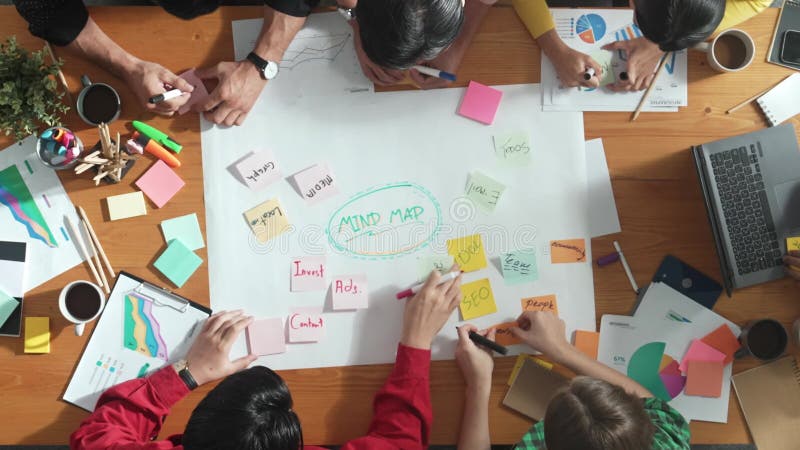 Business People Writing at Notes and Making Mind Map at Meeting ...