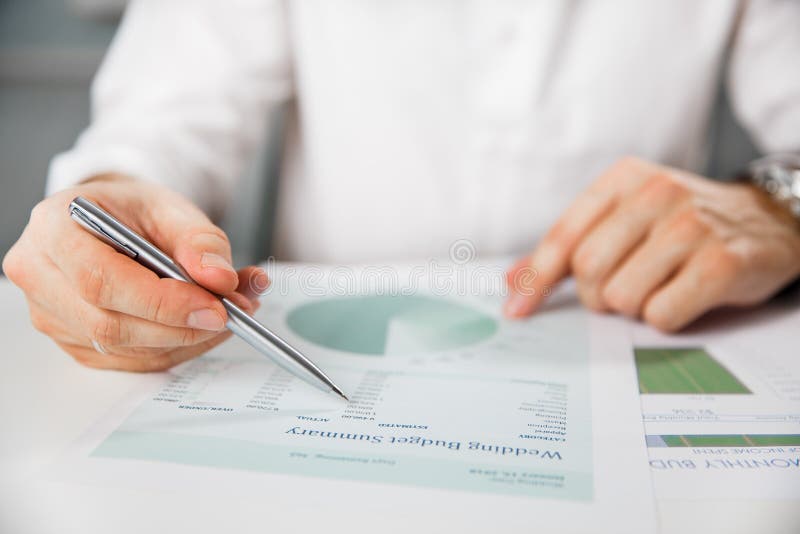 Business Person Analyzing Financial Statistics Displayed on the Tablet ...