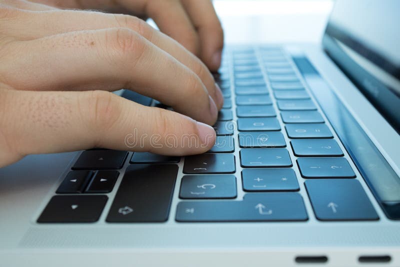 Business Person Using the Keyboard of a Laptop on a White Table. Person ...