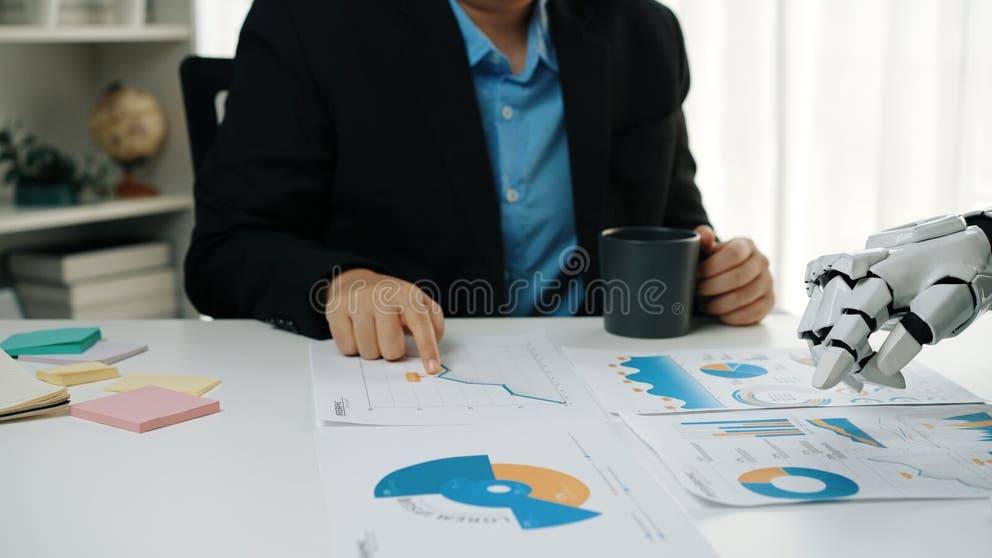 Business Professional Analyzing Data and Reports while Collaborating ...