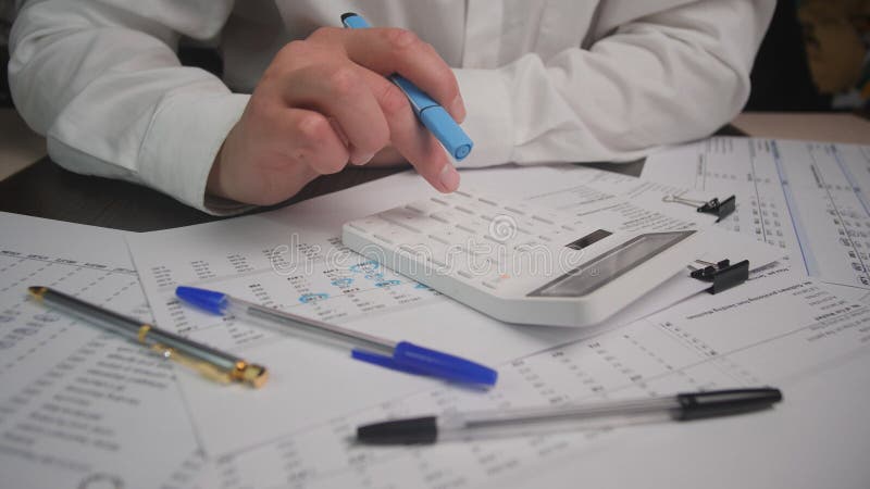 Business Professional Calculating Finances with a Calculator, Notes ...