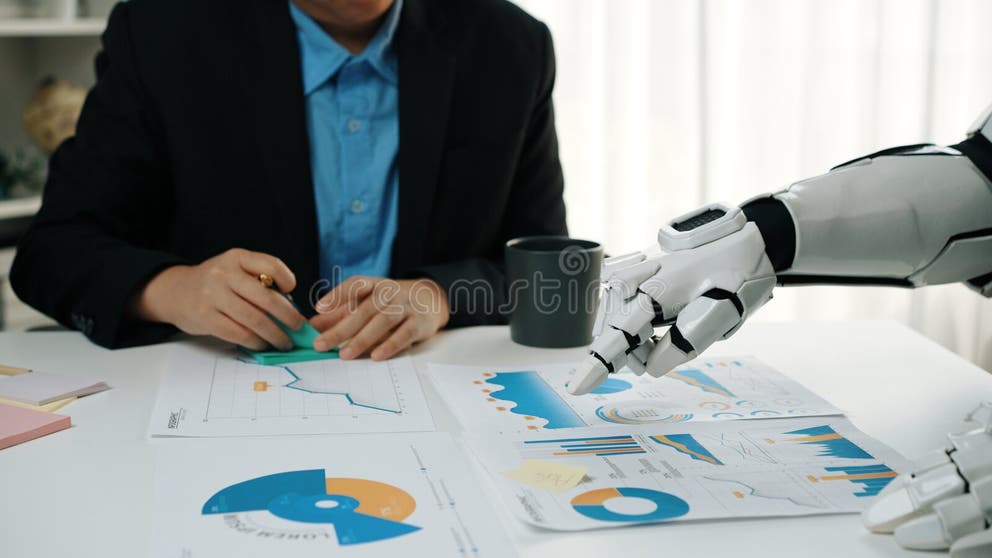 Business Professional Collaborating with a Robot Arm while Analyzing ...