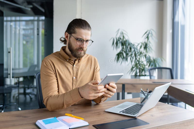 Business Professional Using a Tablet in a Modern Office Workspace Stock ...