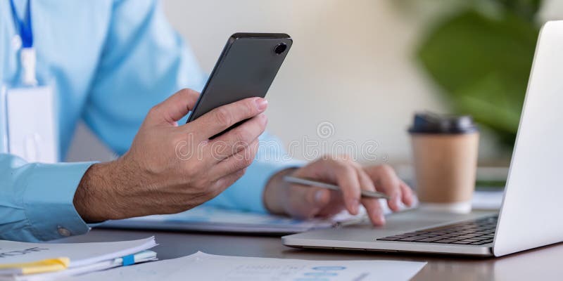 Business Professional Multitasking with Smartphone and Laptop in Modern ...