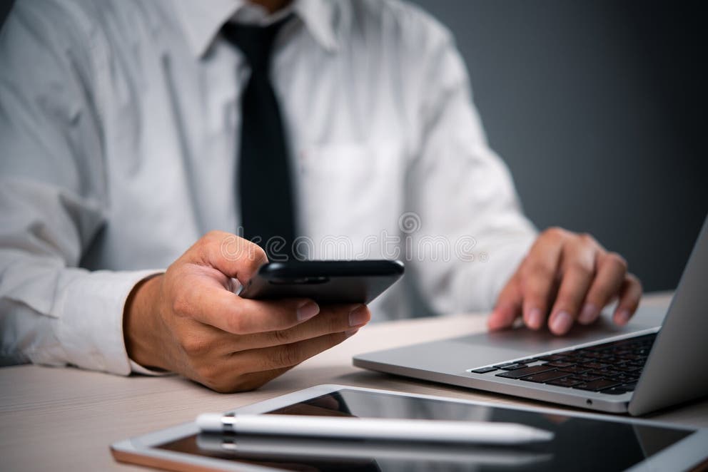 Business Professional Multitasking Using a Smartphone and Laptop ...
