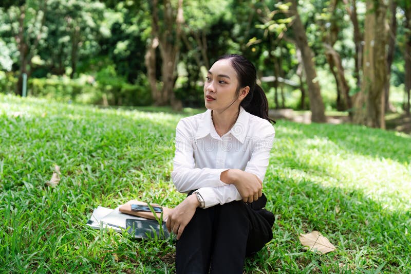 Business Professional Taking a Break Outdoors in a Park Setting ...