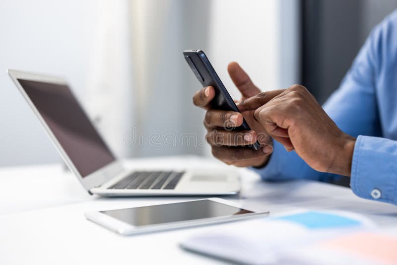 Business Professional Using Smartphone and Laptop in Modern Office ...