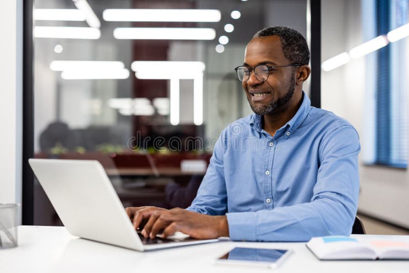 Professional Man Working on Laptop in Modern Office, Smiling and ...