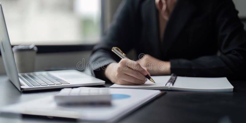 Business Professional Writing Notes at Desk with Laptop and Documents ...