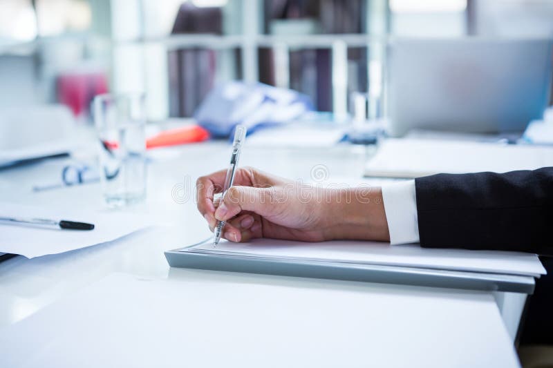 Business Professional Writing Notes on Notepad in Conference Room, with ...