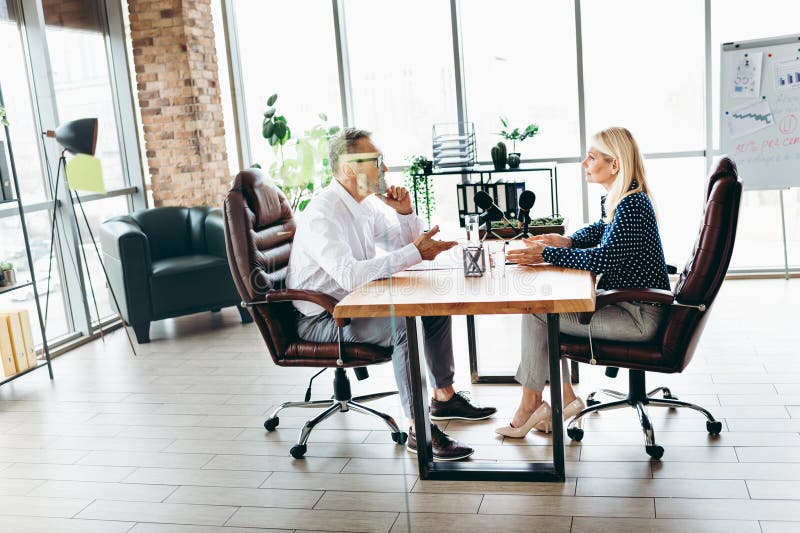 Mature Businesswoman and Businessman Discussing Work Together in a ...