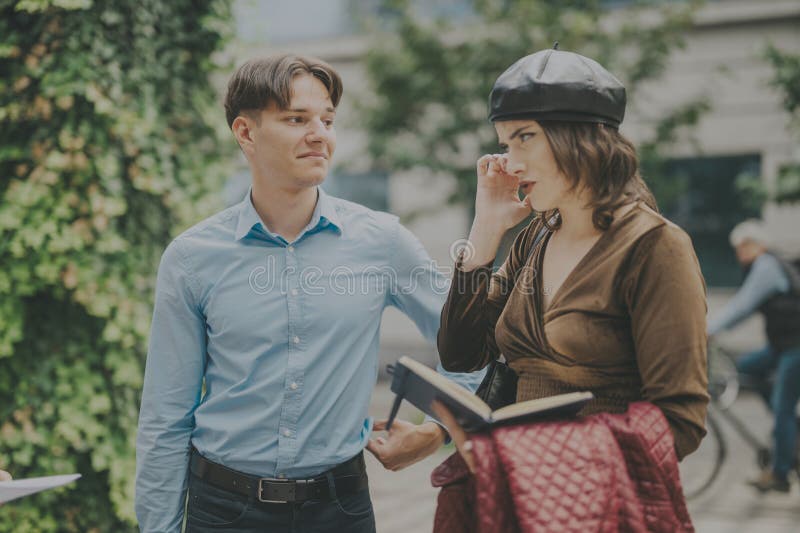 Two Professionals Discussing Project Details in an Outdoor Setting ...