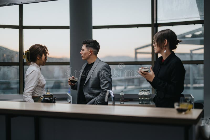 Business Professionals Having a Coffee Break in a Modern Workspace ...