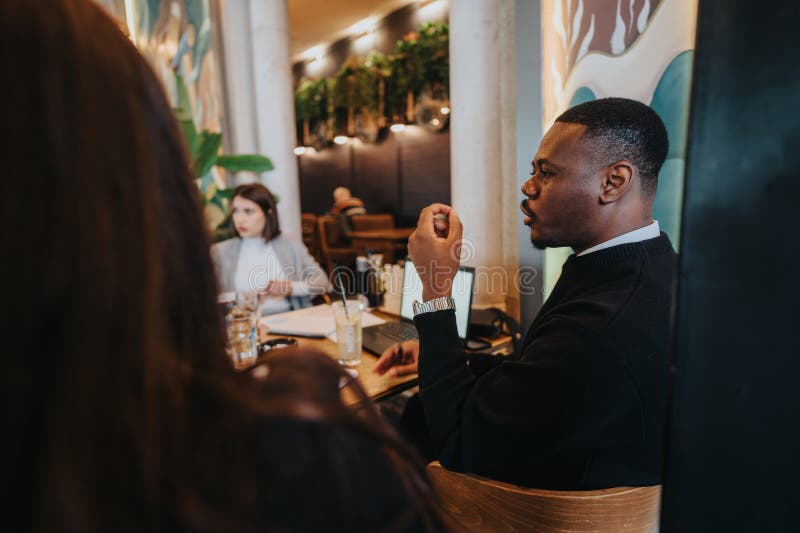 Business Professionals Having a Focused Discussion in a Modern Office ...