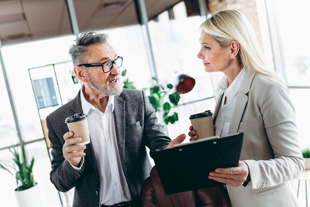 Business Professionals Having a Productive Discussion in a Modern ...