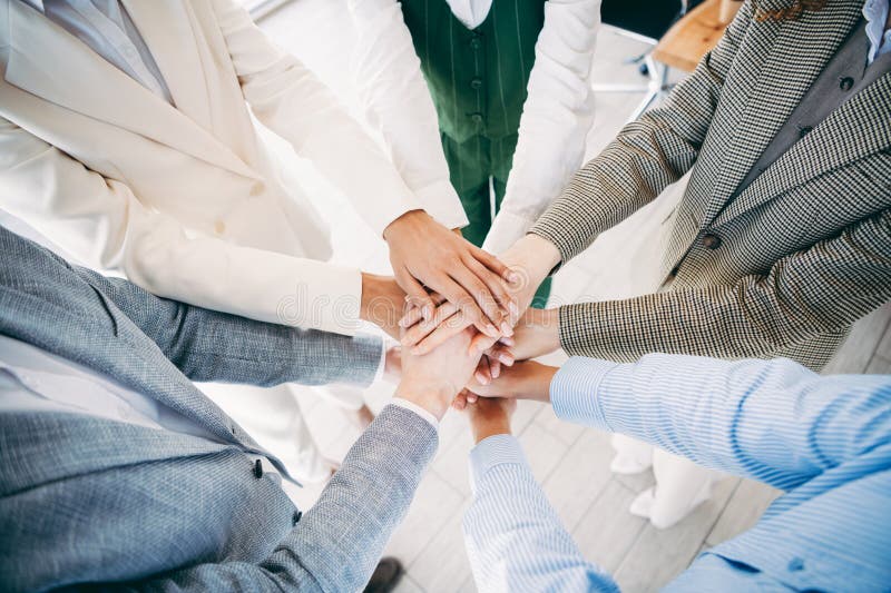 Diverse Work Colleagues Joining Hands Symbolizing Teamwork Collaboration Office Setting Stock ...