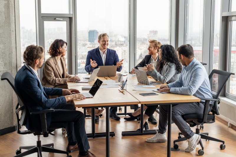 Business Professionals Meeting in Modern Office with Large Windows ...