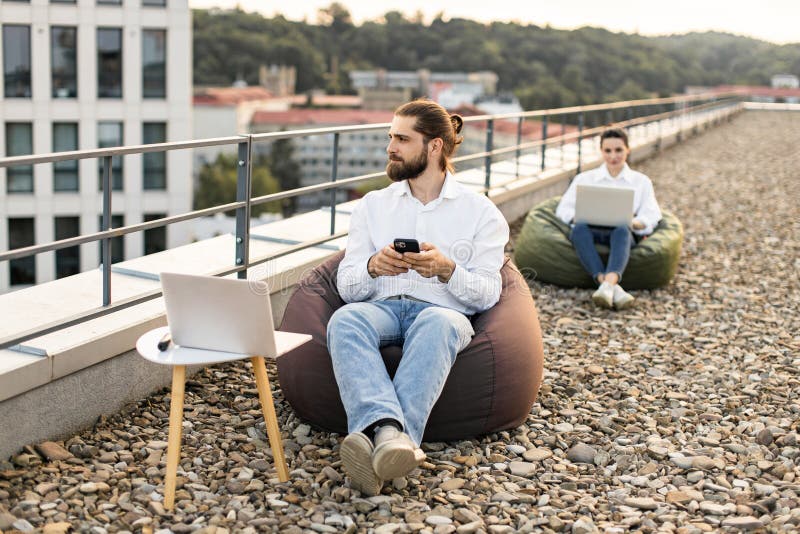 Business Professionals Working Remotely on Rooftop with Laptops Stock ...