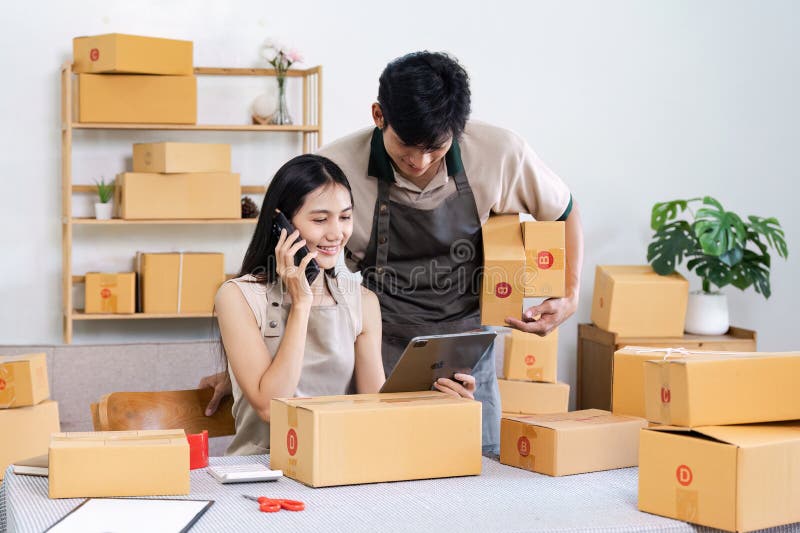 Business Startup Owner Working from Home Packaging Products and Using ...