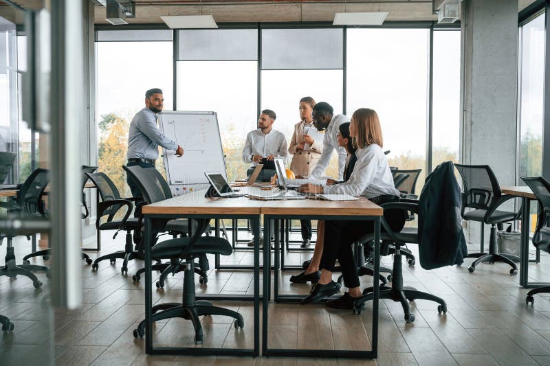 Business Strategy on the Whiteboard. Group of Office Workers are ...