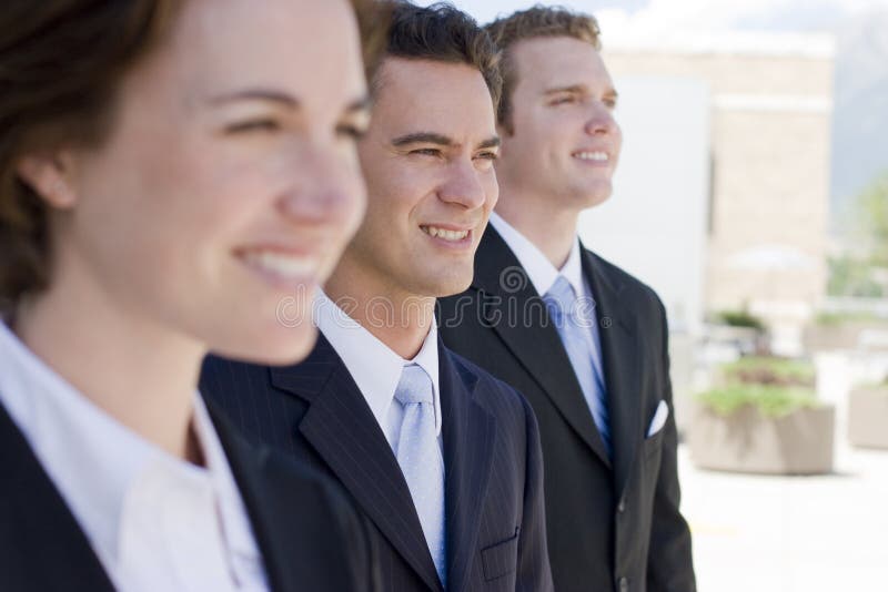 Three Smiling Business People Standing Together Stock Photo - Image of ...