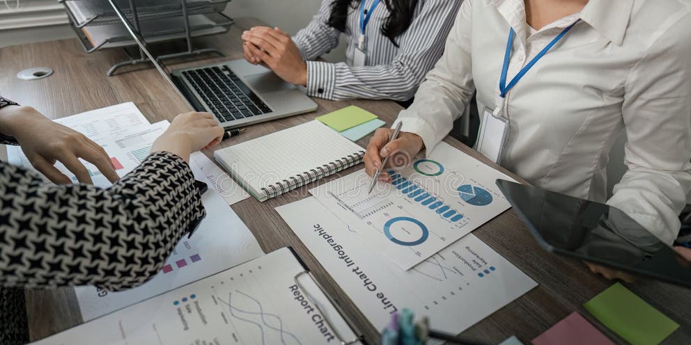 Business Team Analyzing Charts and Data Reports in a Collaborative ...