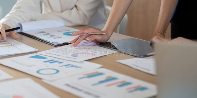 Business Team Analyzing Data Reports and Charts during a Meeting ...
