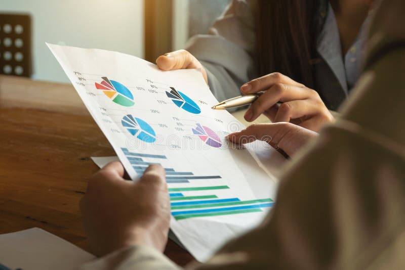 Business Team are Analyzing Graphs Data.Businesswoman Point the Pen at ...