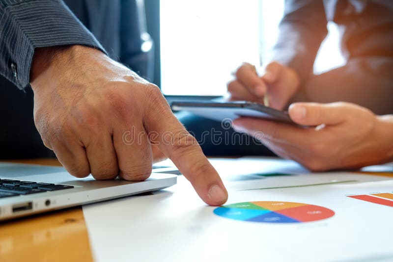 Business Team are Analyzing a Graphs Data with Laptops and Calc Stock ... Business Team are Analyzing a Graphs Data with Laptops and Calc Stock ...