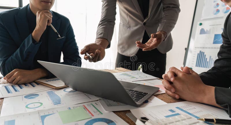 Business Team Analyzing Income Charts and Graphs with Laptop Computer ...