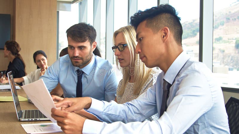 Business Team Around Table in Modern Office Collaborating Together ...
