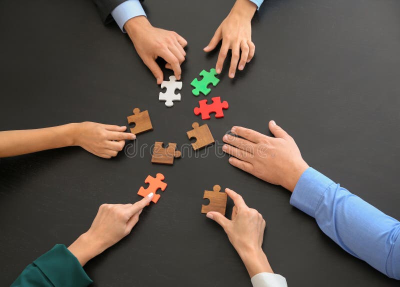 Business Team Assembling Puzzle on Dark Table Stock Image - Image of ...