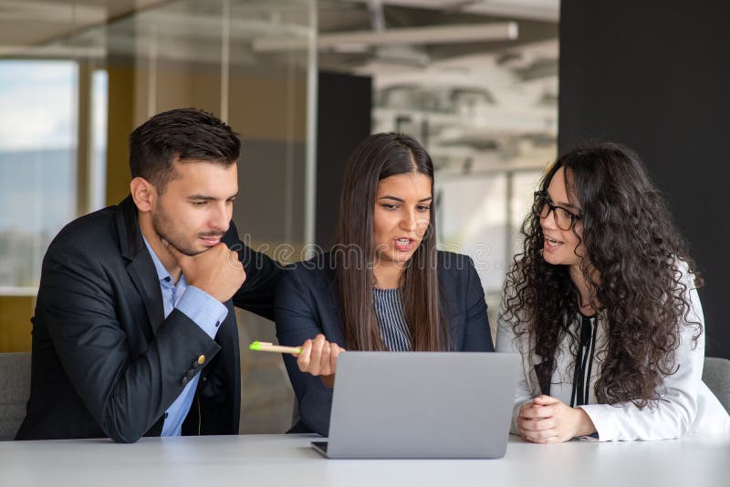 Business Team Collaborating on Project Together, Using Laptops ...