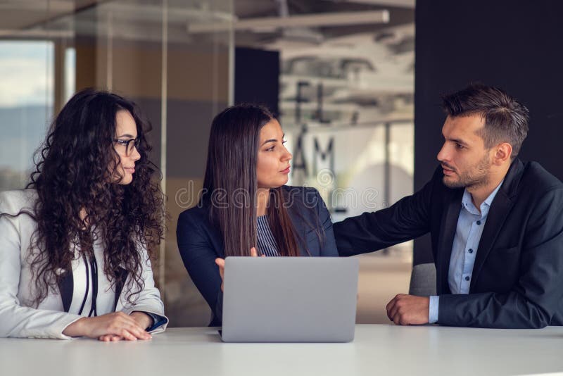 Business Team Collaborating on Project Together, Using Laptops ...