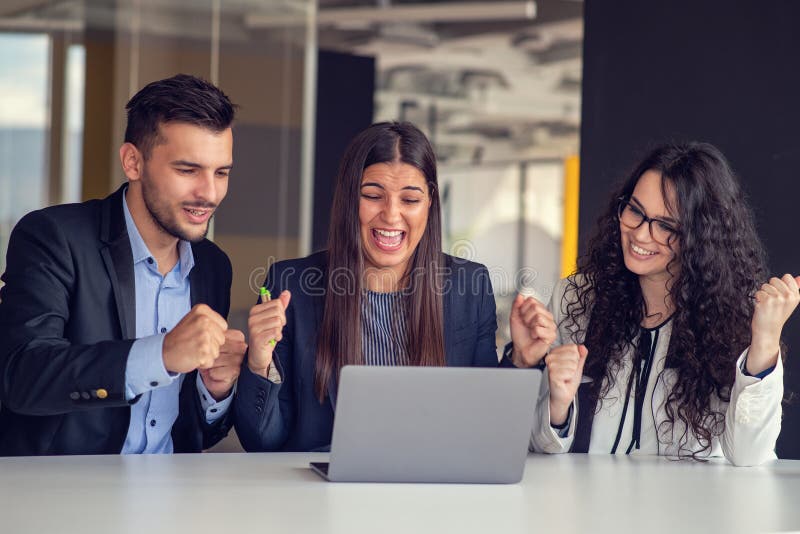 Business Team Collaborating on Project Together, Using Laptops ...