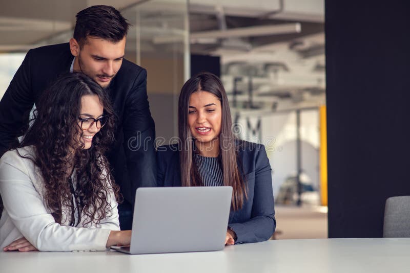 Business Team Collaborating on Project Together, Using Laptops ...