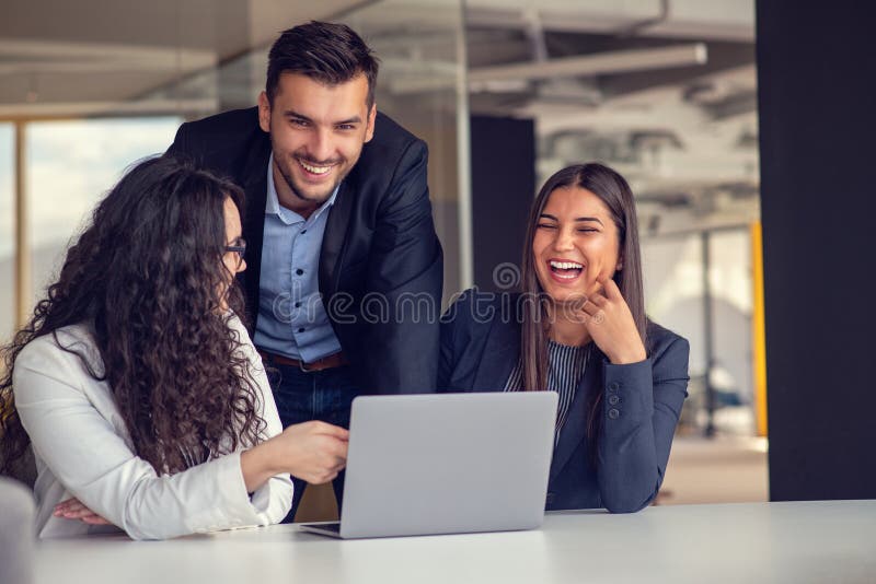 Business Team Collaborating on Project Together, Using Laptops ...
