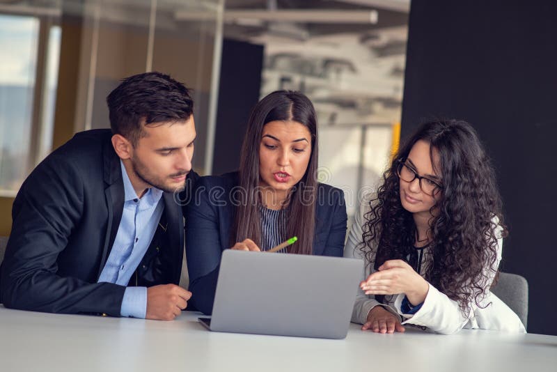 Business Team Collaborating on Project Together, Using Laptops ...