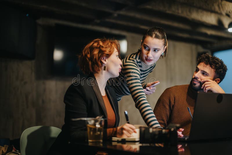 Diverse Business Team Collaborating on Project, Working Late into the ...