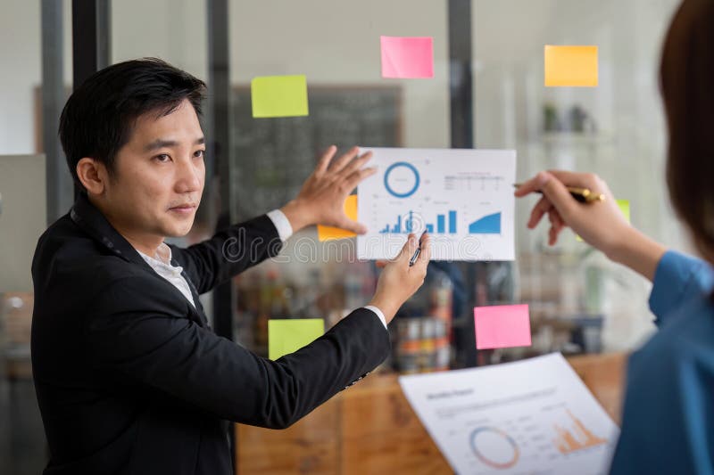 Business Team Discuss Analysis with Charts and Graphs in Modern Office ...