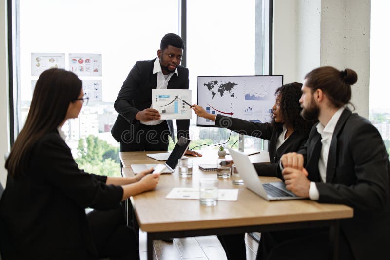 Business Team Discussing Charts during a Meeting in Office Stock Image ...