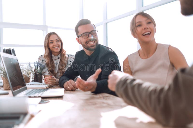 Business Team Discussing Documents Sitting at the Table Stock Photo ...