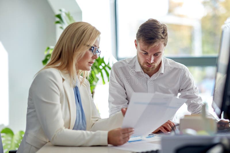 Business Team Discussing Papers at Office Table Stock Image - Image of ...