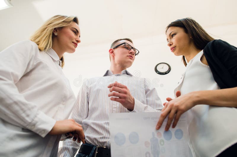 Business Team Discussing Some Charts. Bottom View Stock Image - Image ... Business Team Discussing Some Charts. Bottom View Stock Image - Image ...