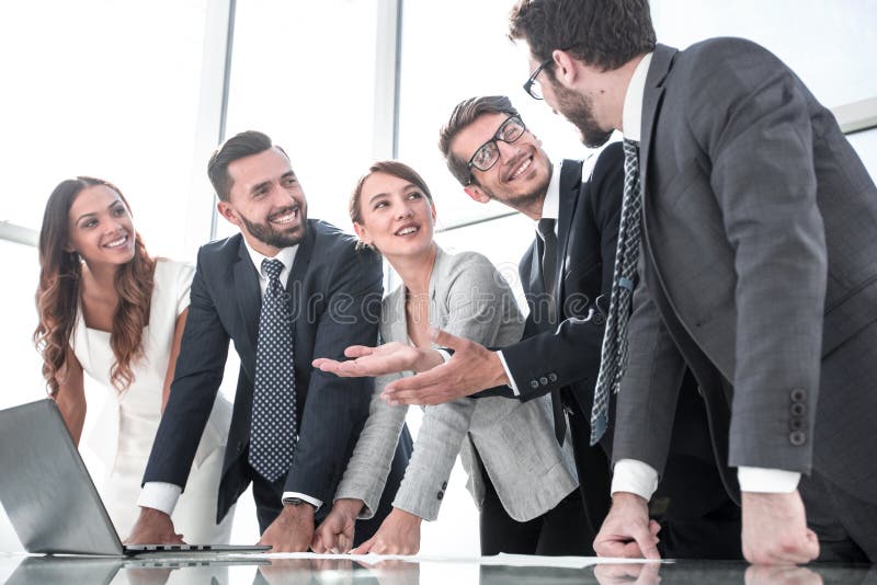 Business Team Discussing Something while Standing Near the Desktop ... Business Team Discussing Something while Standing Near the Desktop ...