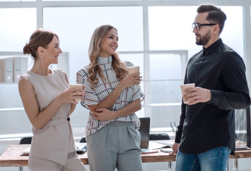 Business Team Discussing Something Standing in the Office Stock Image ... Business Team Discussing Something Standing in the Office Stock Image ...