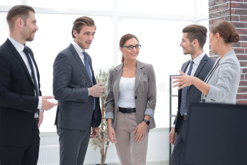 Business Team Discussing while Standing in the Office Stock Photo ...