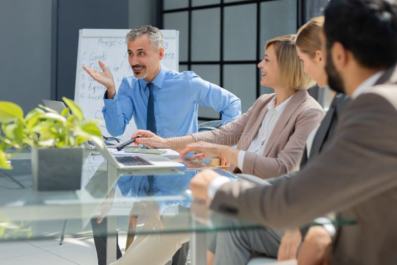 Business Team Discussing Together Business Plans in Office. Stock Photo ...